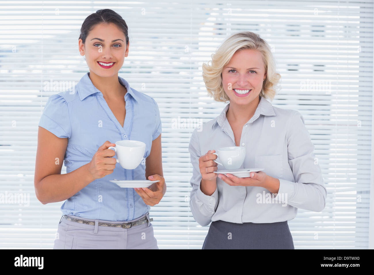 Cheerful coworkers smiling Stock Photo - Alamy