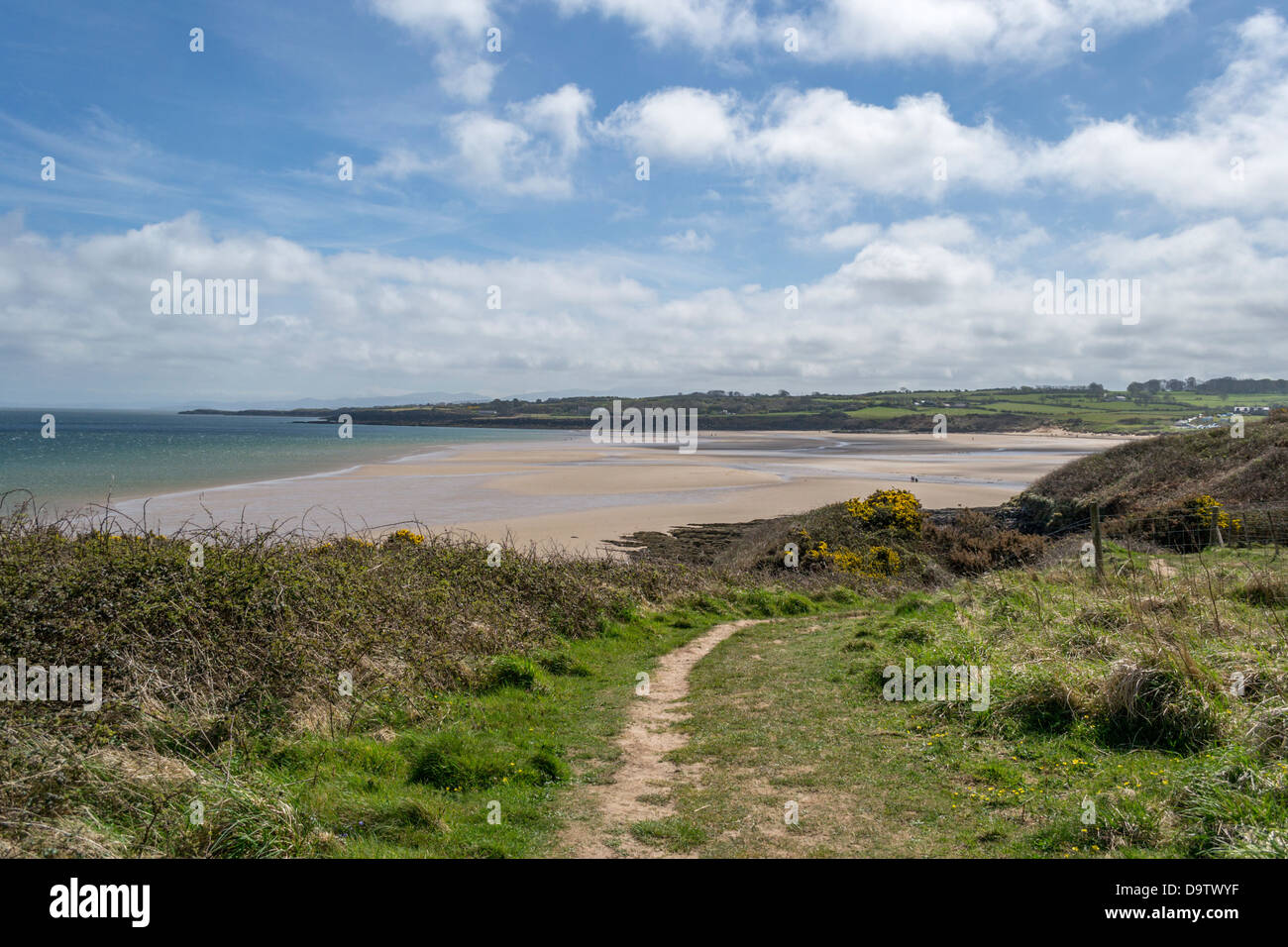 A view of LLigwy beach on the Isle of Anglesey with the coastal path in ...