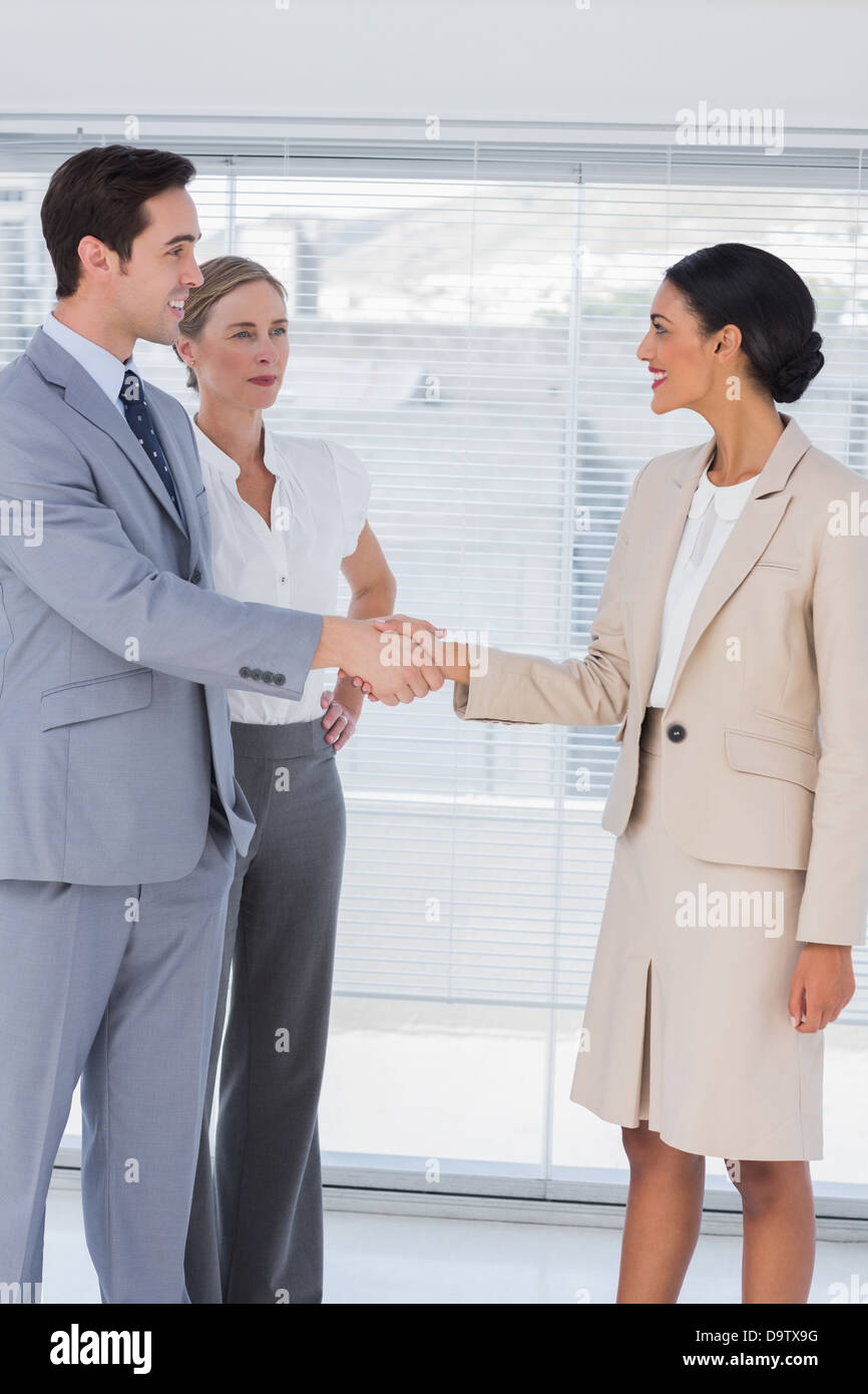 Business people shaking hands in bright office Stock Photo - Alamy