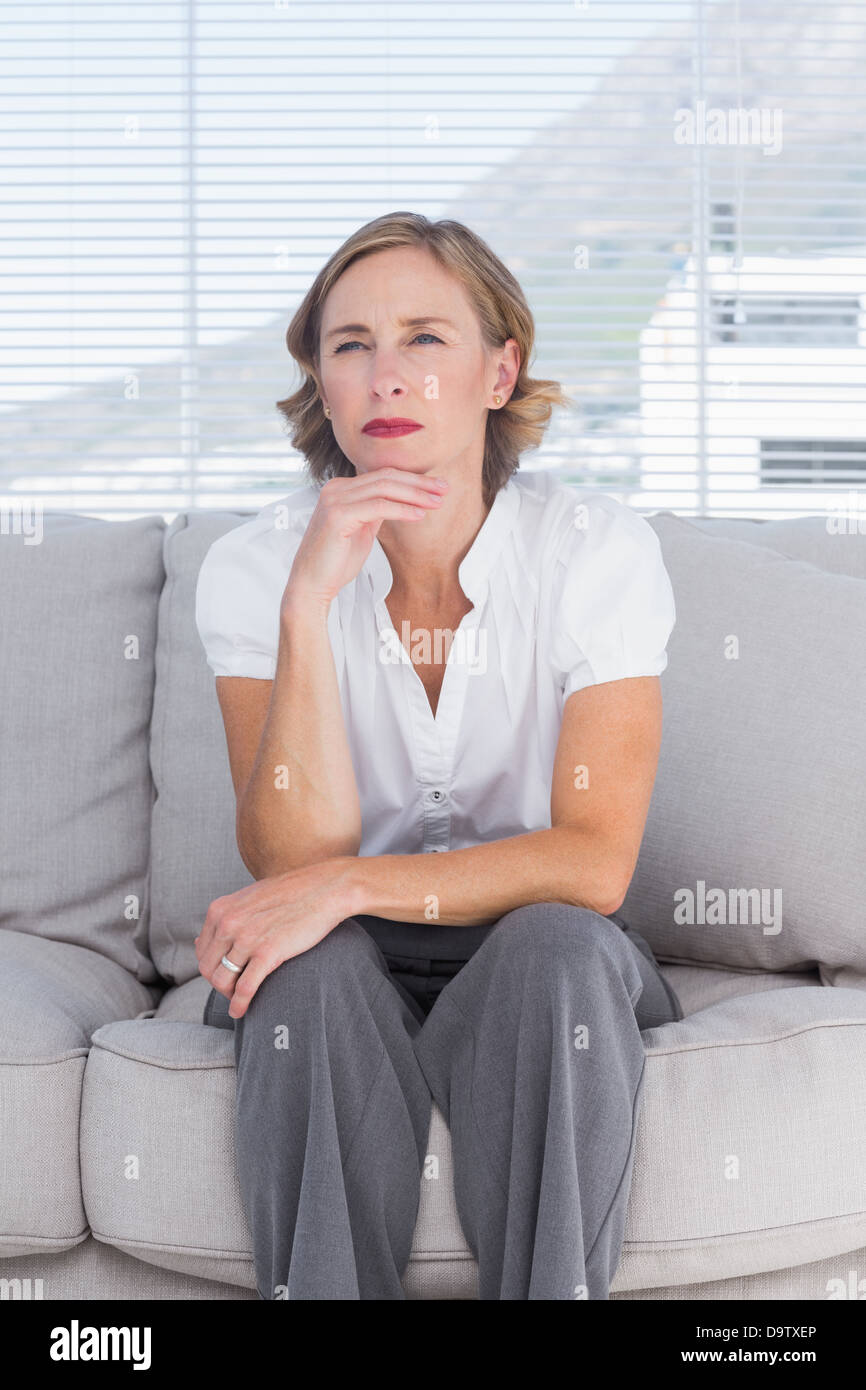 Thinking businesswoman sitting on sofa hi-res stock photography and ...