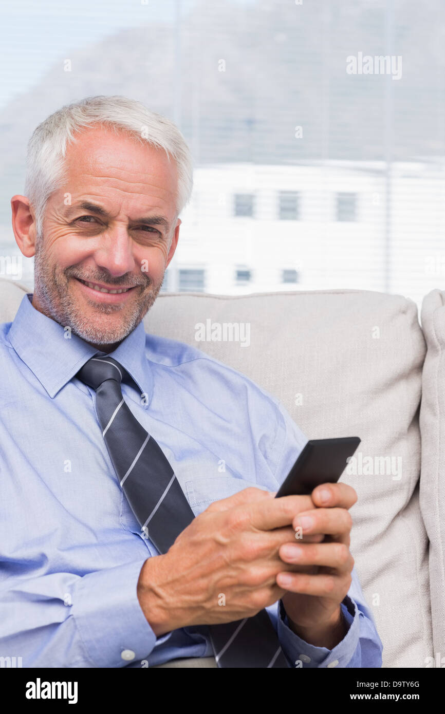 Portrait smiling businessman smartphone hi-res stock photography and ...