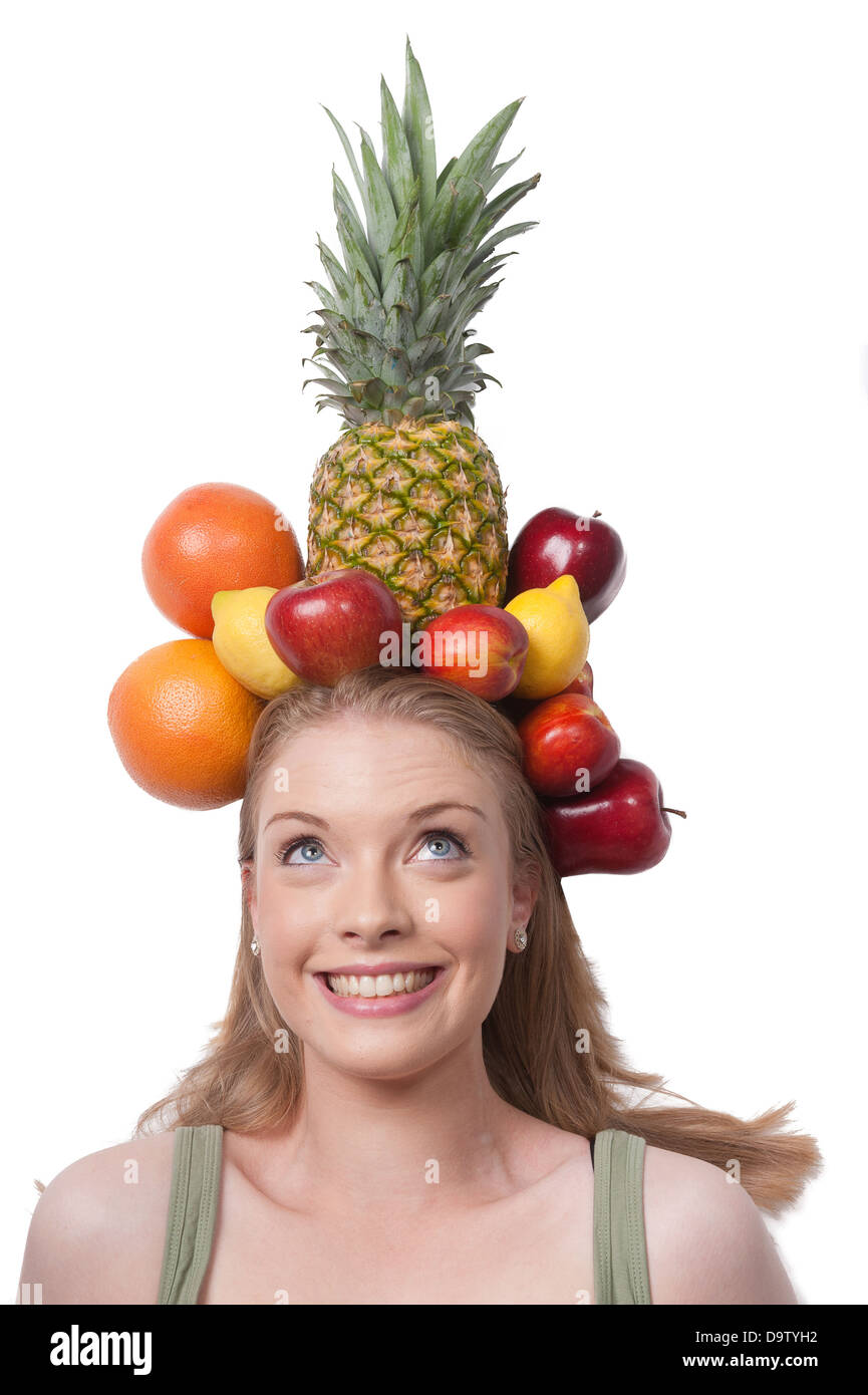 Cute young woman wearing fruit on her head - humorous healthy eating ...