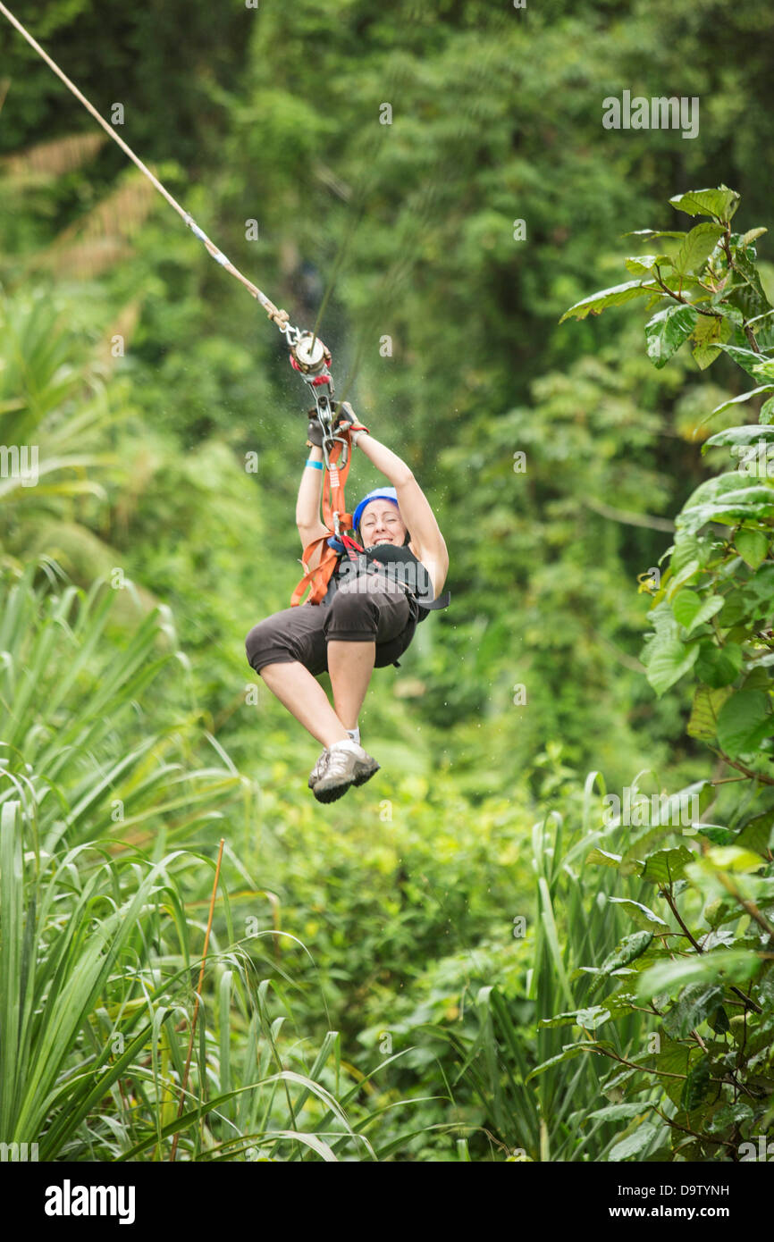 Woman riding a zip line in a forest, Costa Rica Stock Photo - Alamy