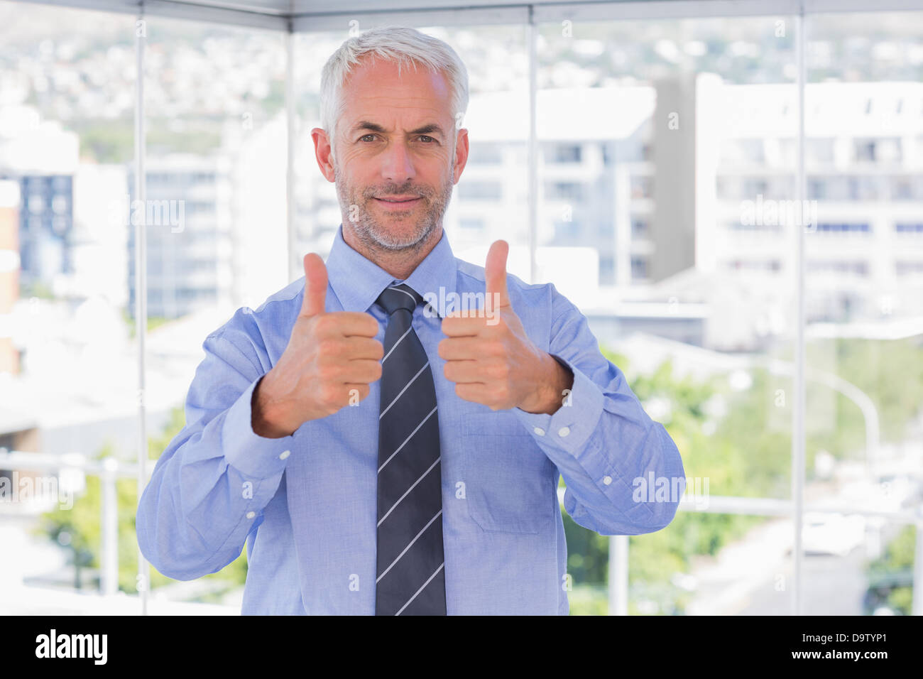Confident businessman smiling thumbs up hi-res stock photography and ...