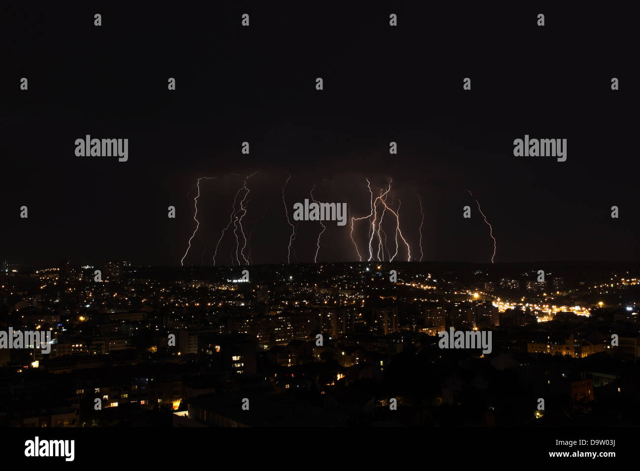 Multiple lightning strikes over a big city by night Stock Photo - Alamy