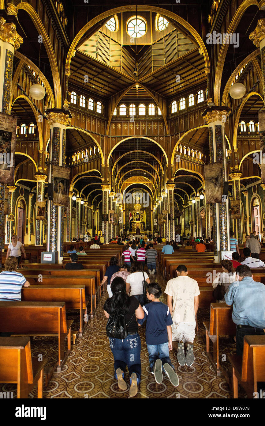 Worshipers praying at the Basilica Nuestra Senora De Los Angeles ...