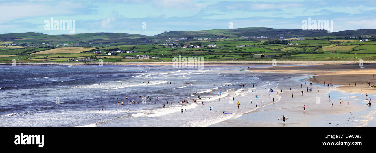 A busy beach with swimmers and surfers;Lahinch county clare ireland ...