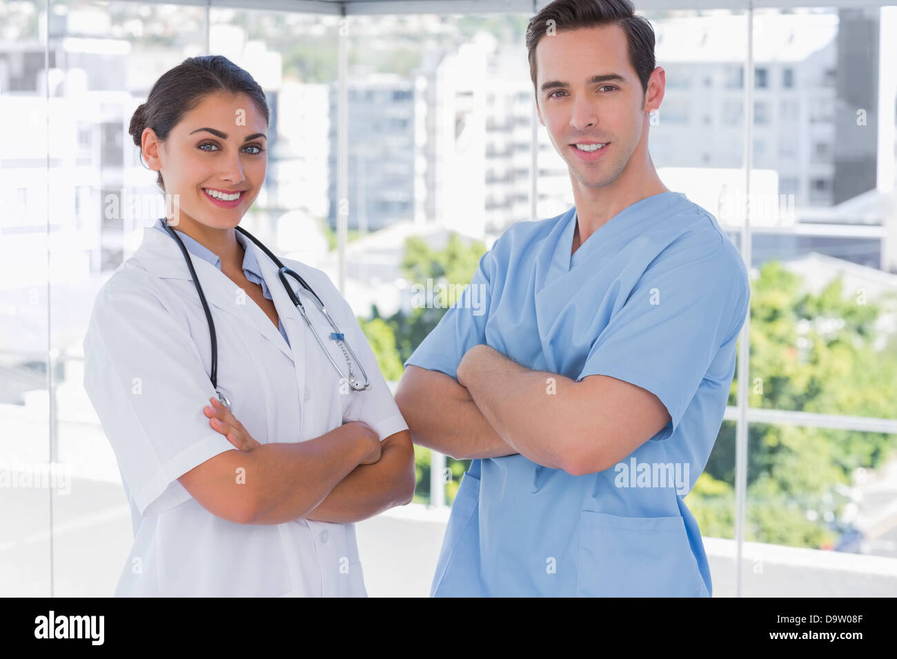 Medical staff standing together with arms folded Stock Photo - Alamy