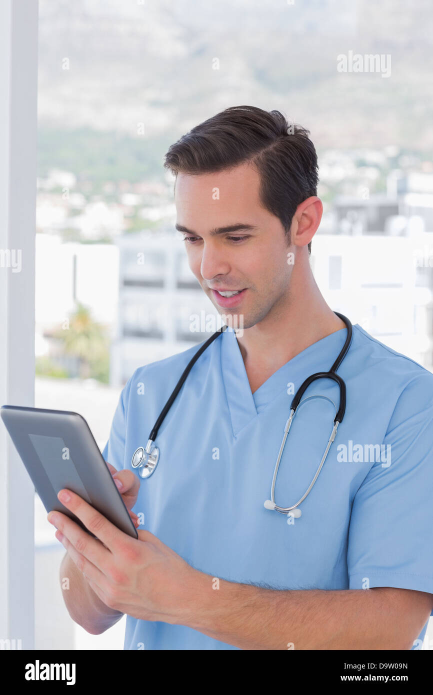 Male nurse working on a tablet pc Stock Photo - Alamy