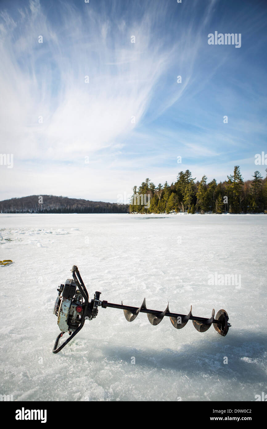 USA, New York State, Adirondack, Two-stroke ice fishing auger on frozen ...