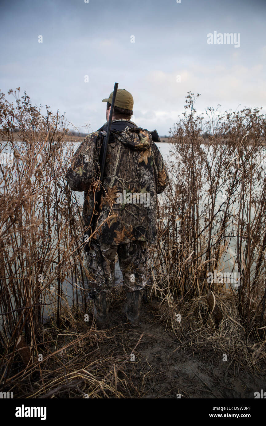 Duck hunter looking for ducks out over lake Stock Photo - Alamy