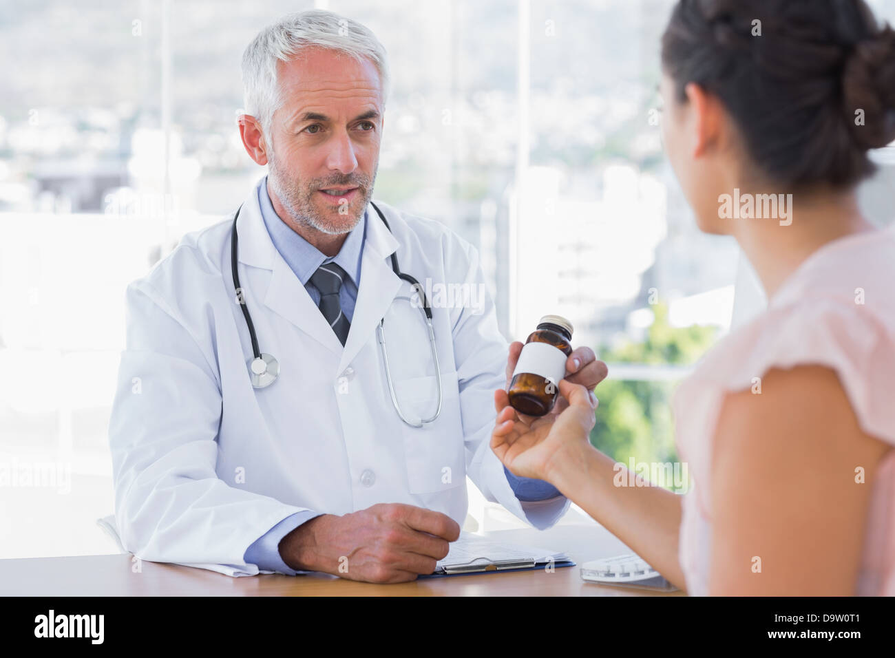 Doctor handing drugs patient hi-res stock photography and images - Alamy