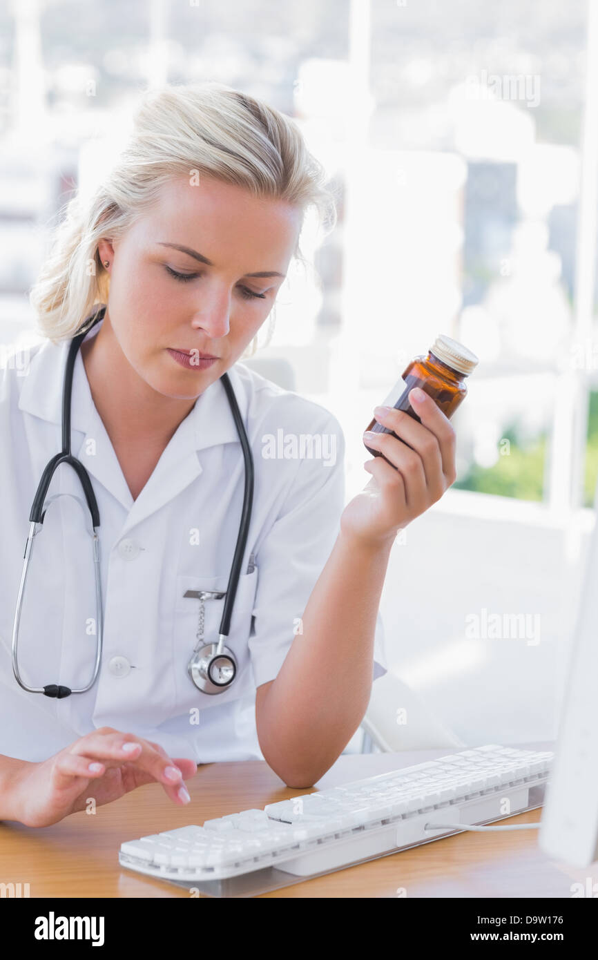 Nurse holding a medicine jar Stock Photo - Alamy