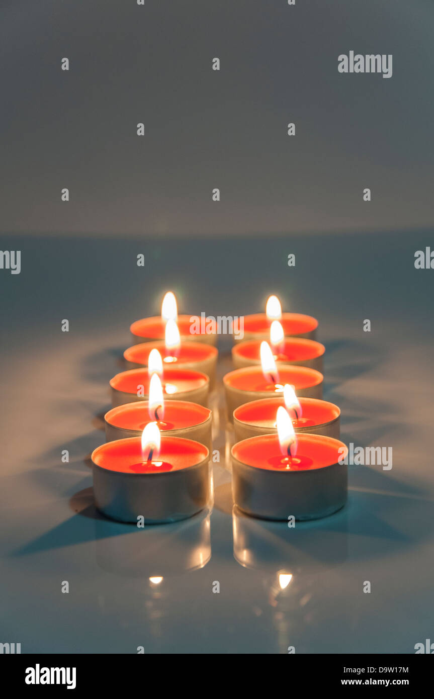 illuminating red color candles wall Stock Photo - Alamy