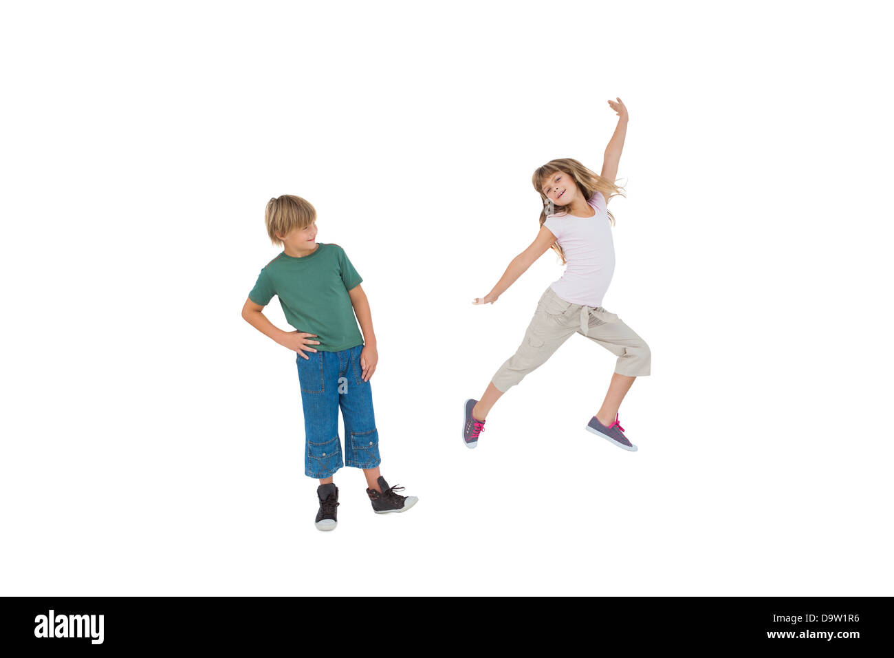 Happy little boy and girl jumping Stock Photo - Alamy