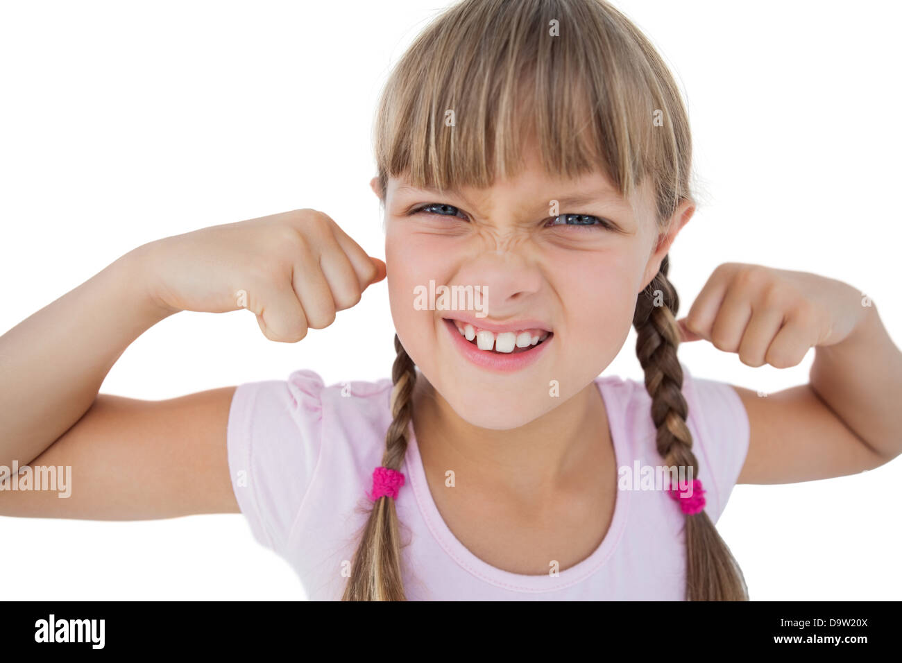 Little girl tensing her arm muscles Stock Photo - Alamy