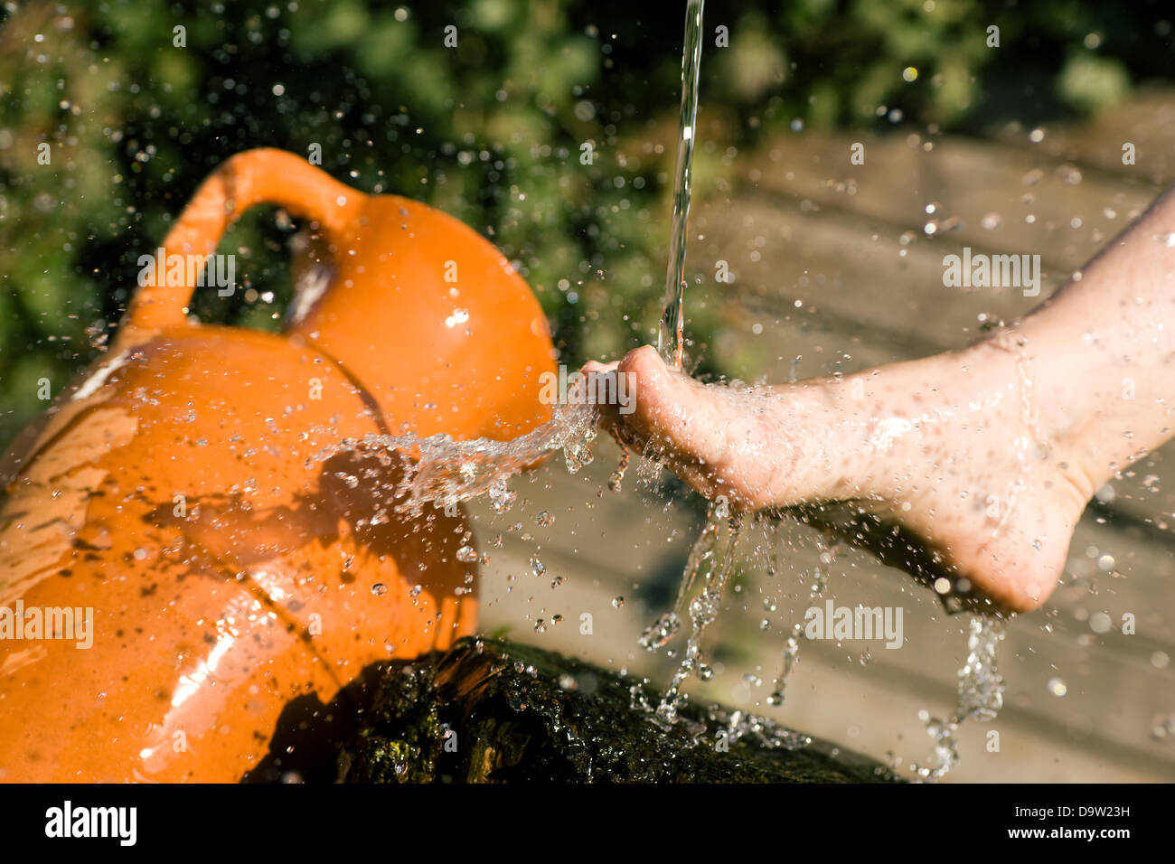 Splash of cold water showered on feet in an alternative therapy session ...