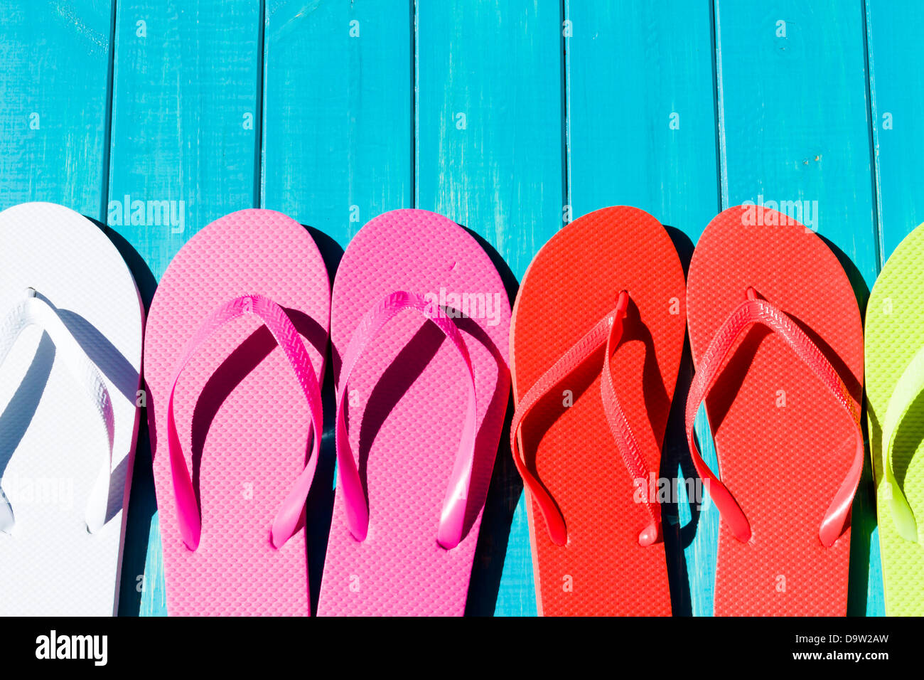Colorful flip flops by a swimming pool Stock Photo - Alamy