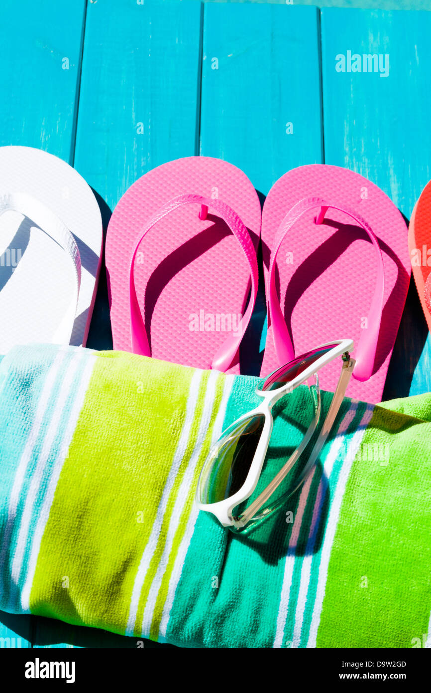 Colorful flip flops by a swimming pool Stock Photo - Alamy