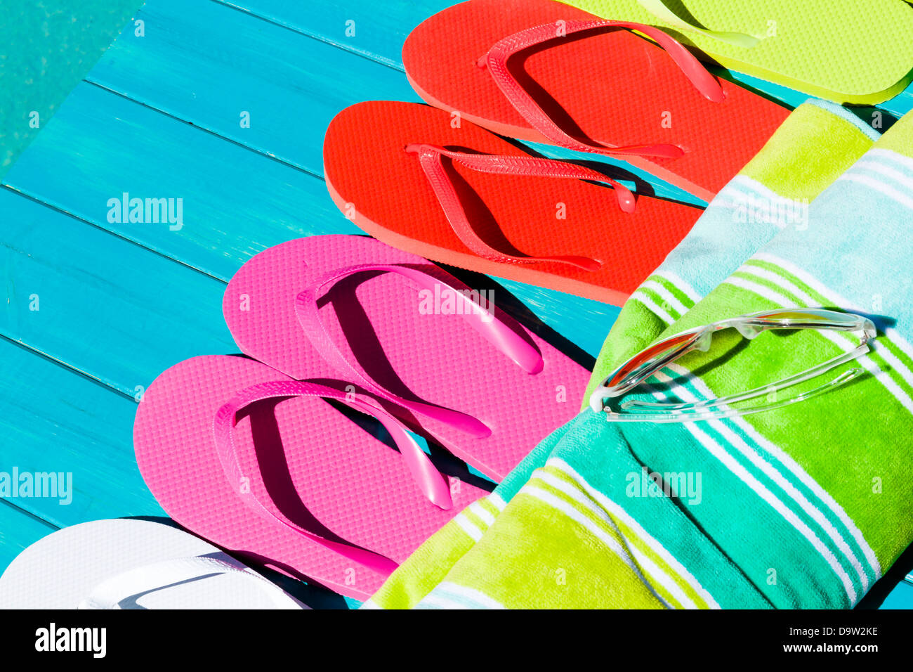 Colorful flip flops by a swimming pool Stock Photo - Alamy