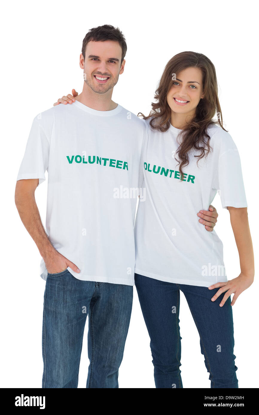 Two cheerful people wearing volunteer tshirt Stock Photo - Alamy