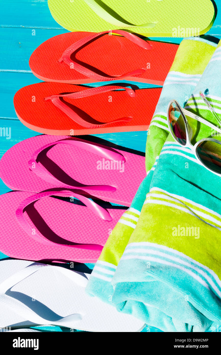 Colorful flip flops by a swimming pool Stock Photo - Alamy