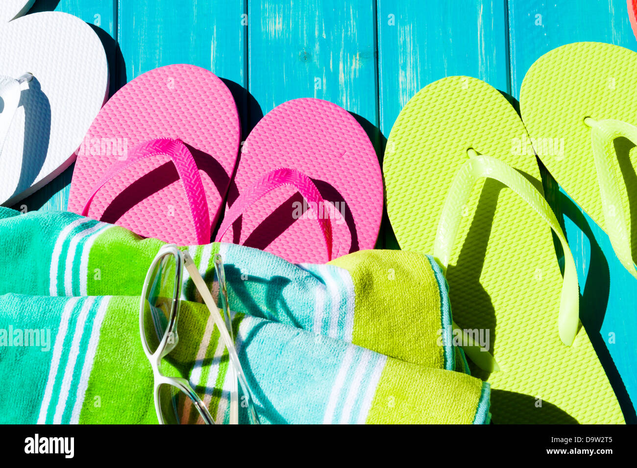 Colorful flip flops by a swimming pool Stock Photo - Alamy