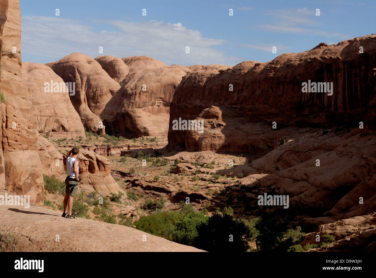 Man admiring the stunning scenery with standing on a giant arch on the ...