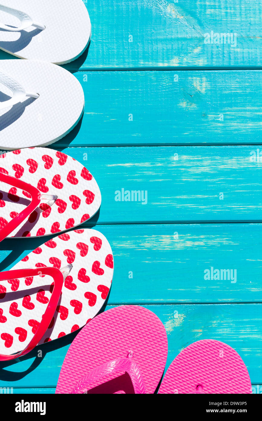 Colorful flip flops by a swimming pool Stock Photo - Alamy