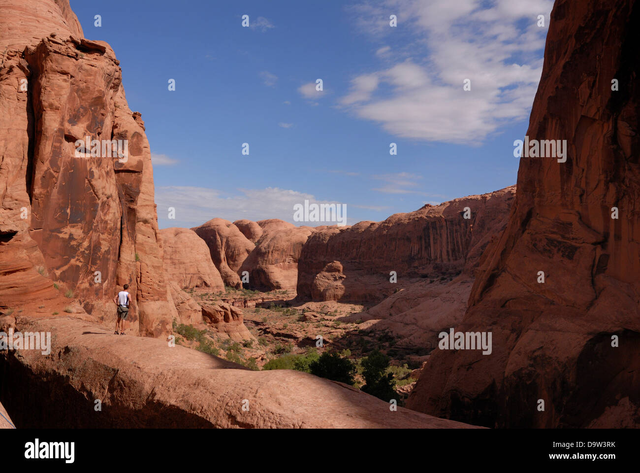 Man admiring the stunning scenery with standing on a giant arch on the ...