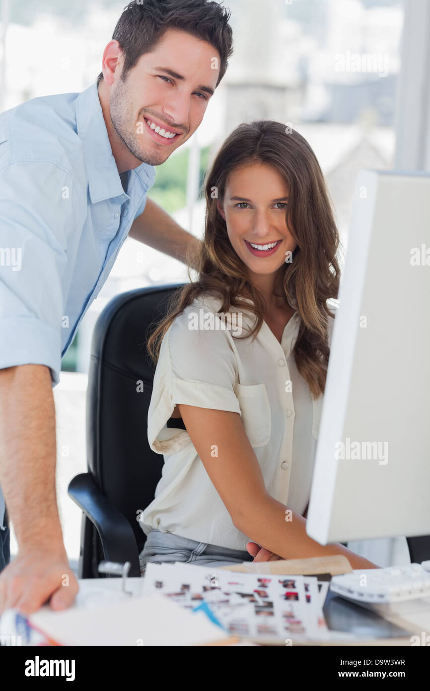 Happy photo editors working together on a computer Stock Photo - Alamy