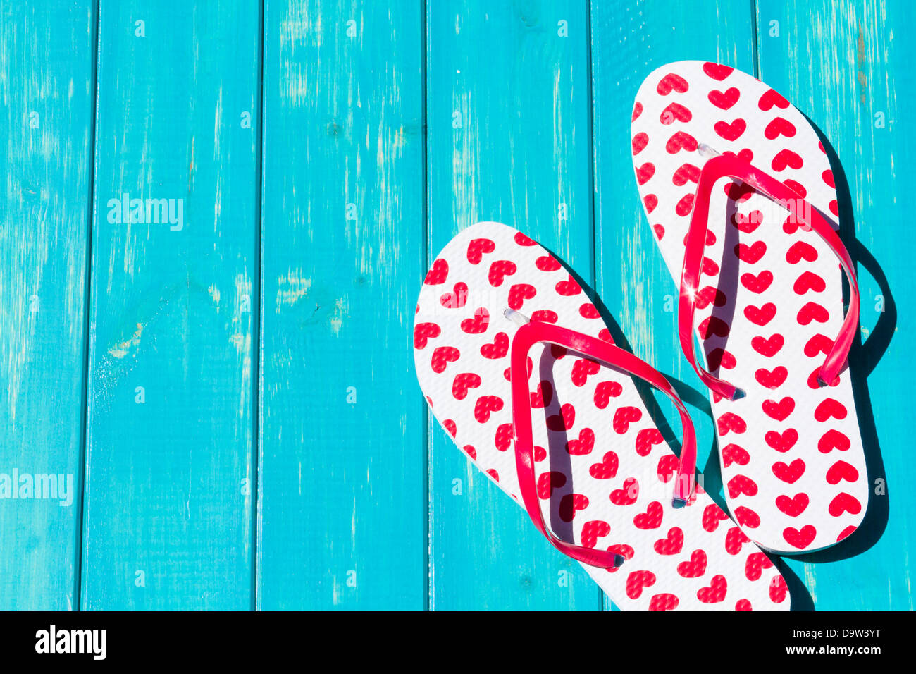 Colorful flip flops by a swimming pool Stock Photo - Alamy