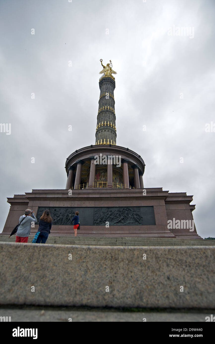 Tourists pose for photographs at the Victory Column, Berlin, Germany ...