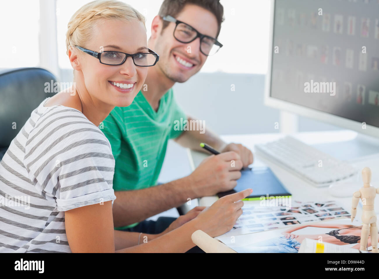 Attractive photo editors working together Stock Photo - Alamy