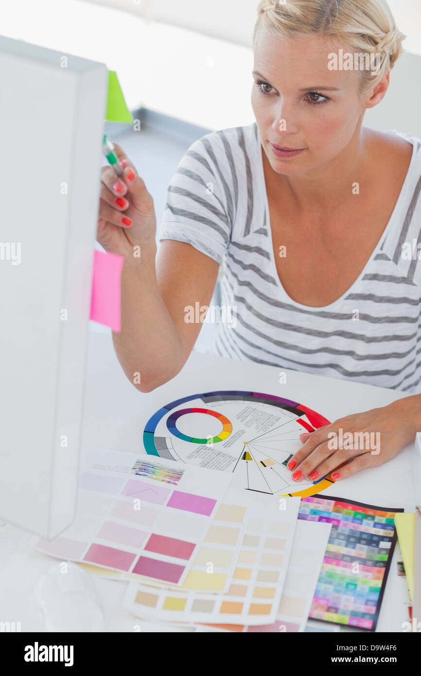 Pretty interior designer working on her computer Stock Photo - Alamy