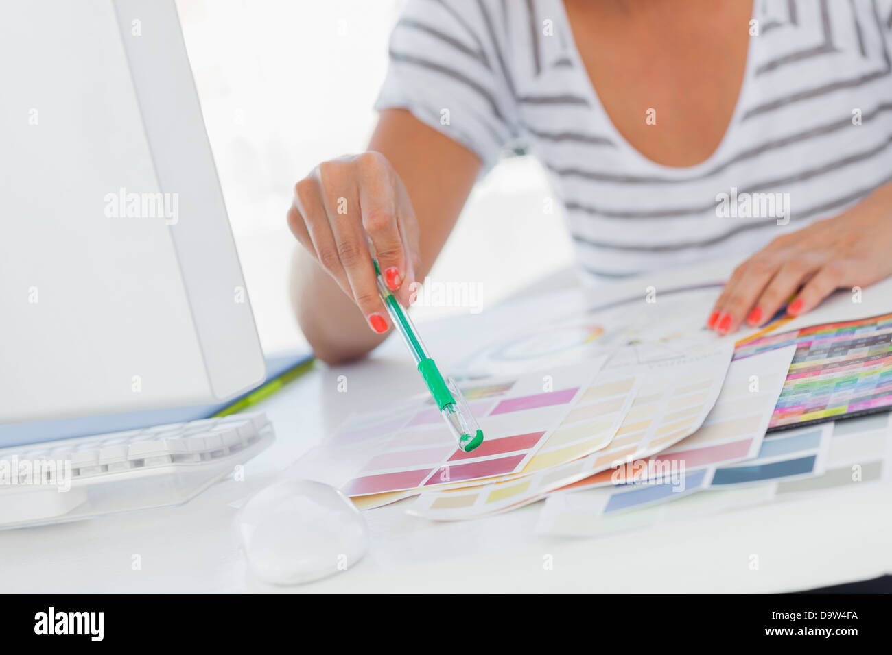 Interior designer pointing at colour charts Stock Photo - Alamy