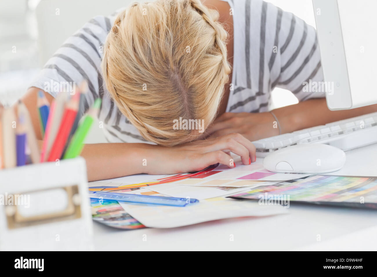 Overworked designer napping on her desk Stock Photo - Alamy