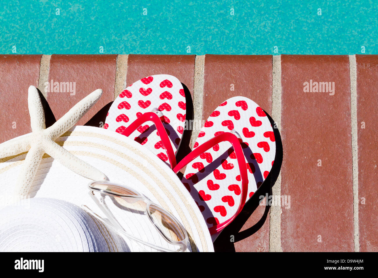 Colorful flip flops by a swimming pool Stock Photo - Alamy