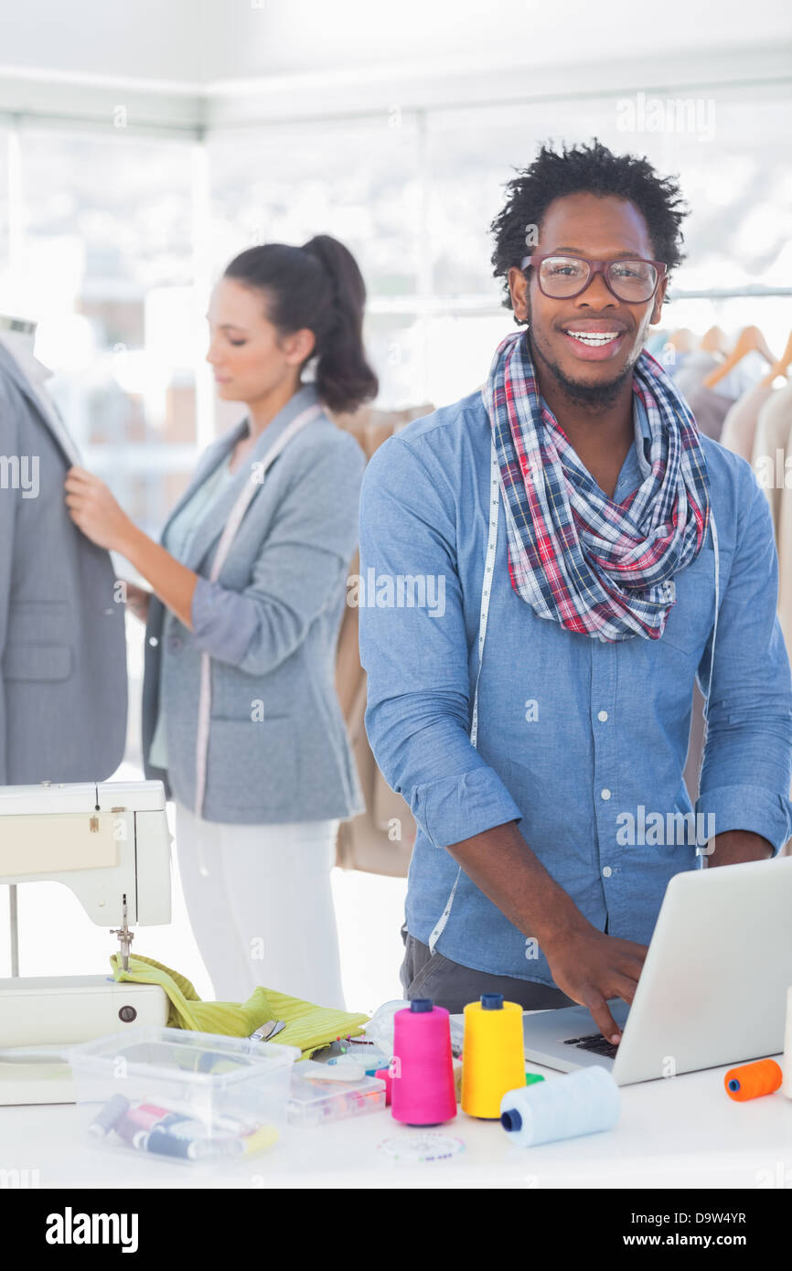 Fashion designer smiling at camera Stock Photo - Alamy