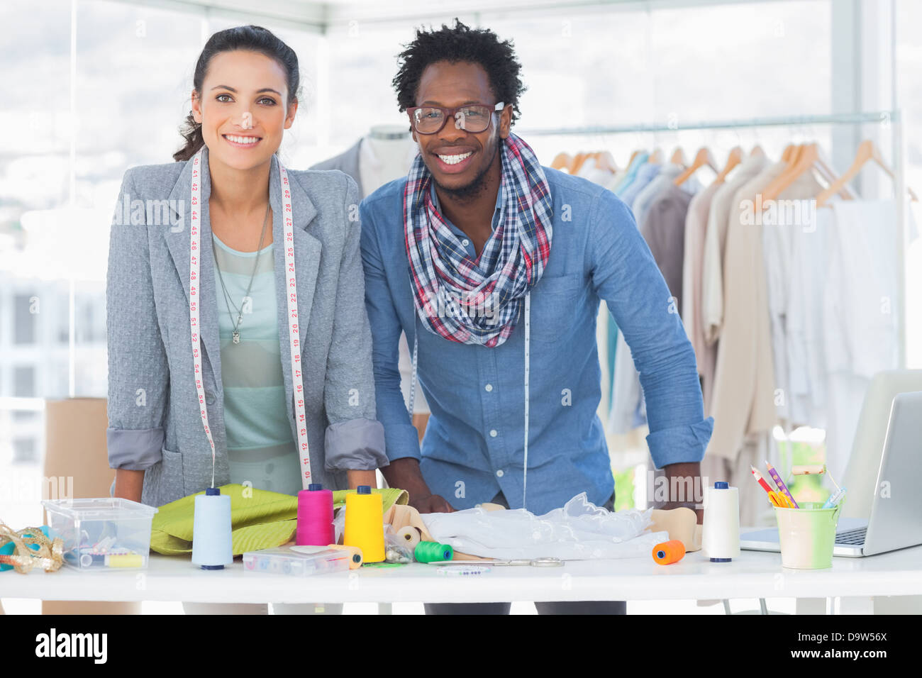 Two fashion designers smiling Stock Photo - Alamy