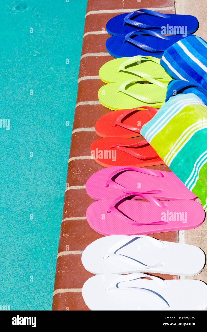 Colorful flip flops by a swimming pool Stock Photo - Alamy