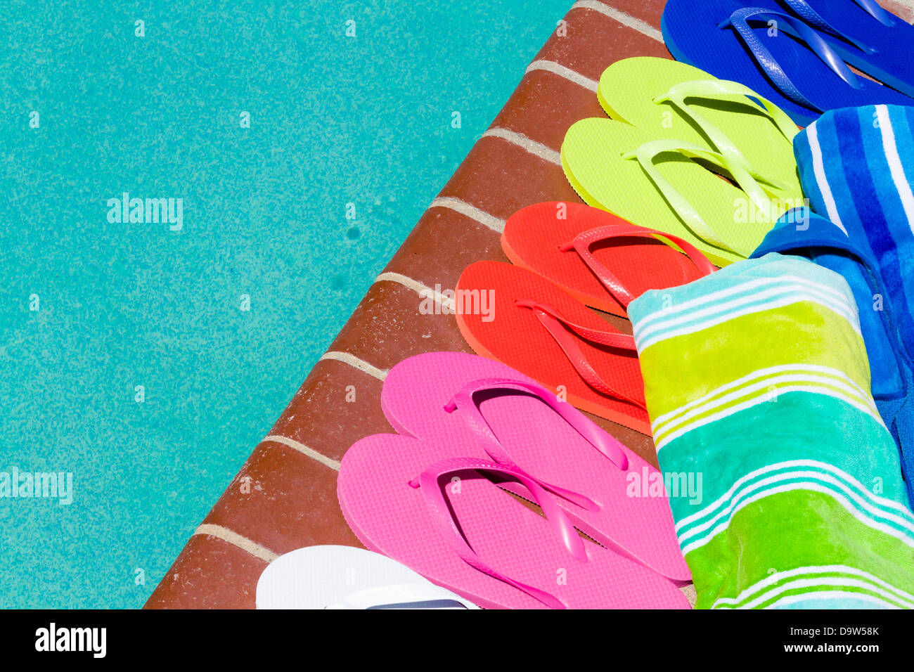 Colorful flip flops by a swimming pool Stock Photo - Alamy