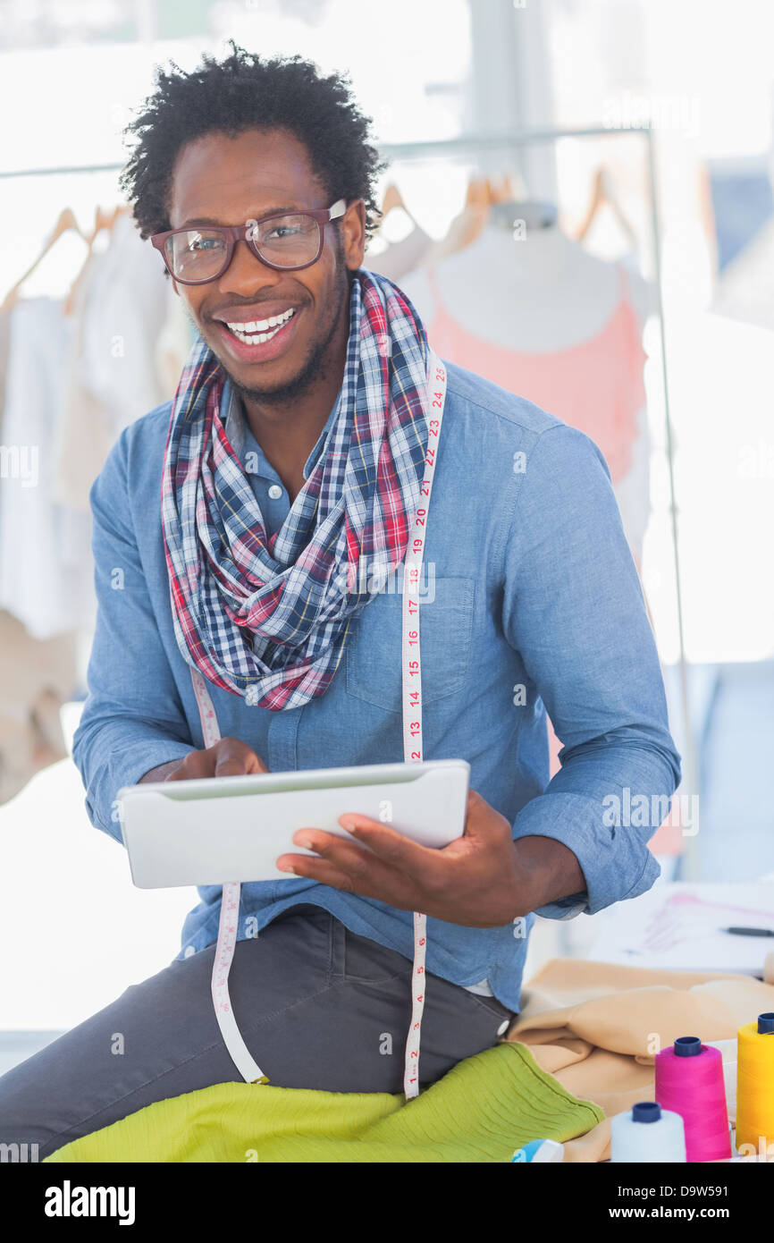 Handsome fashion designer using digital tablet Stock Photo - Alamy