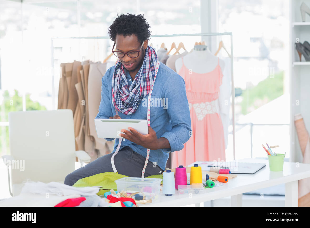 Fashion designer using digital tablet Stock Photo - Alamy