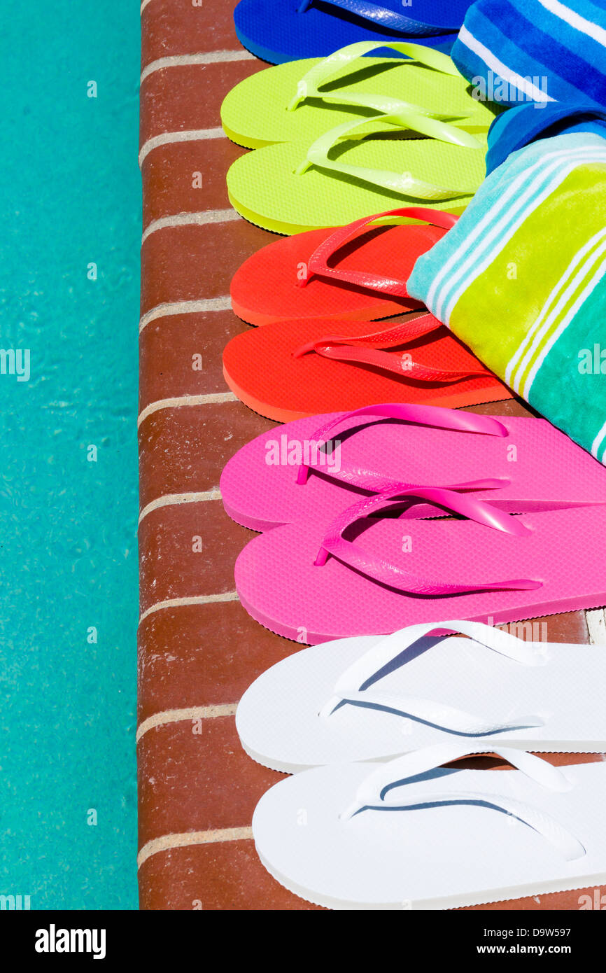 Colorful flip flops by a swimming pool Stock Photo - Alamy