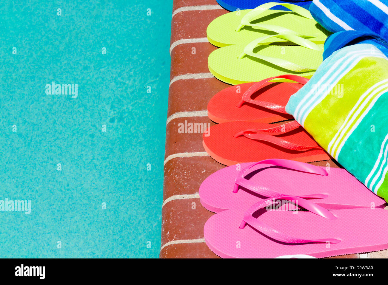 Colorful flip flops by a swimming pool Stock Photo - Alamy