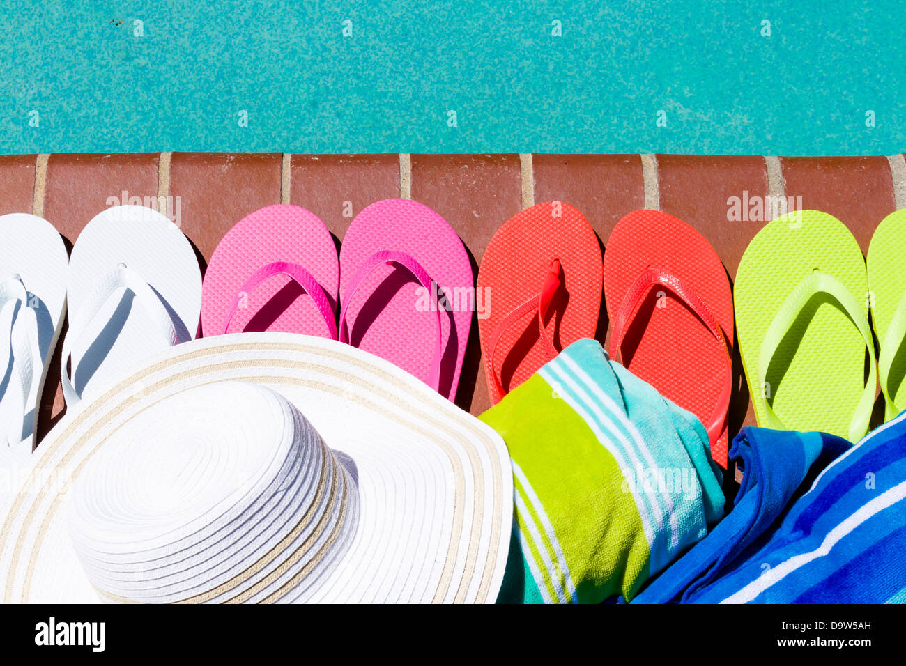 Colorful flip flops by a swimming pool Stock Photo - Alamy