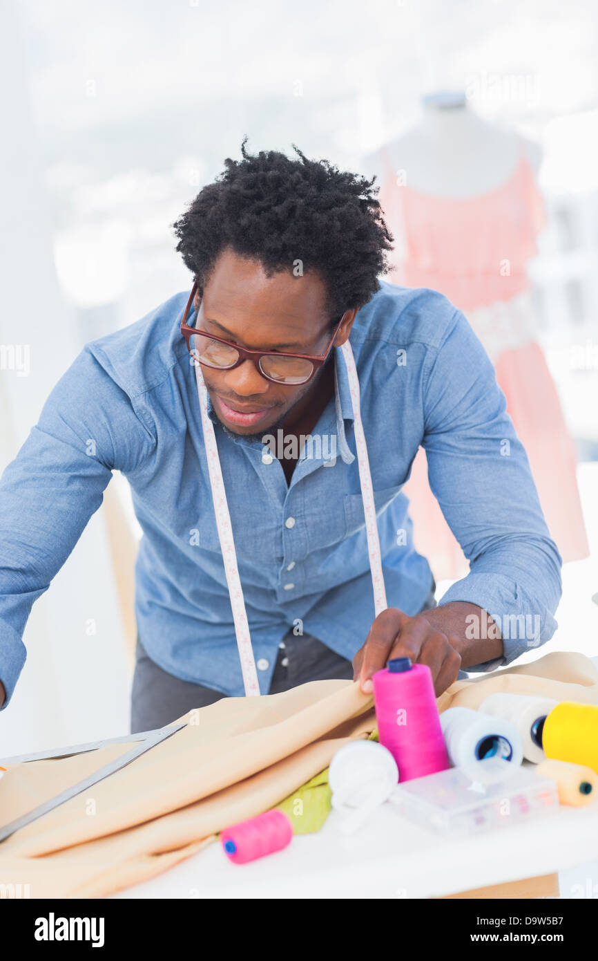 Fashion designer holding textile Stock Photo - Alamy