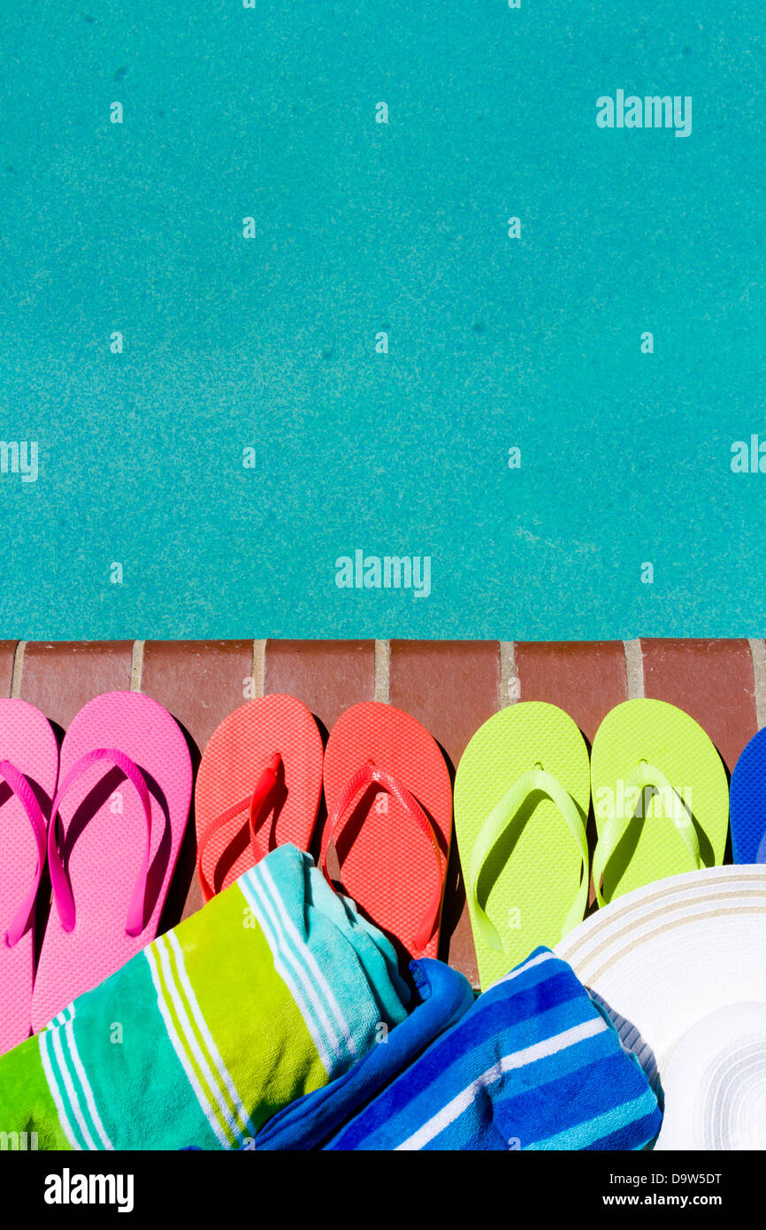 Colorful flip flops by a swimming pool Stock Photo - Alamy