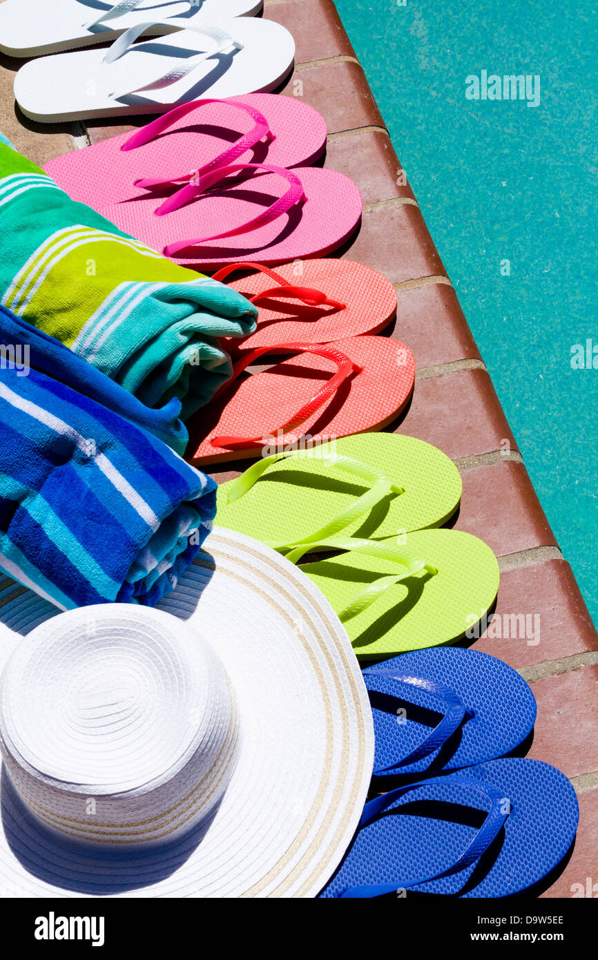 Colorful flip flops by a swimming pool Stock Photo - Alamy